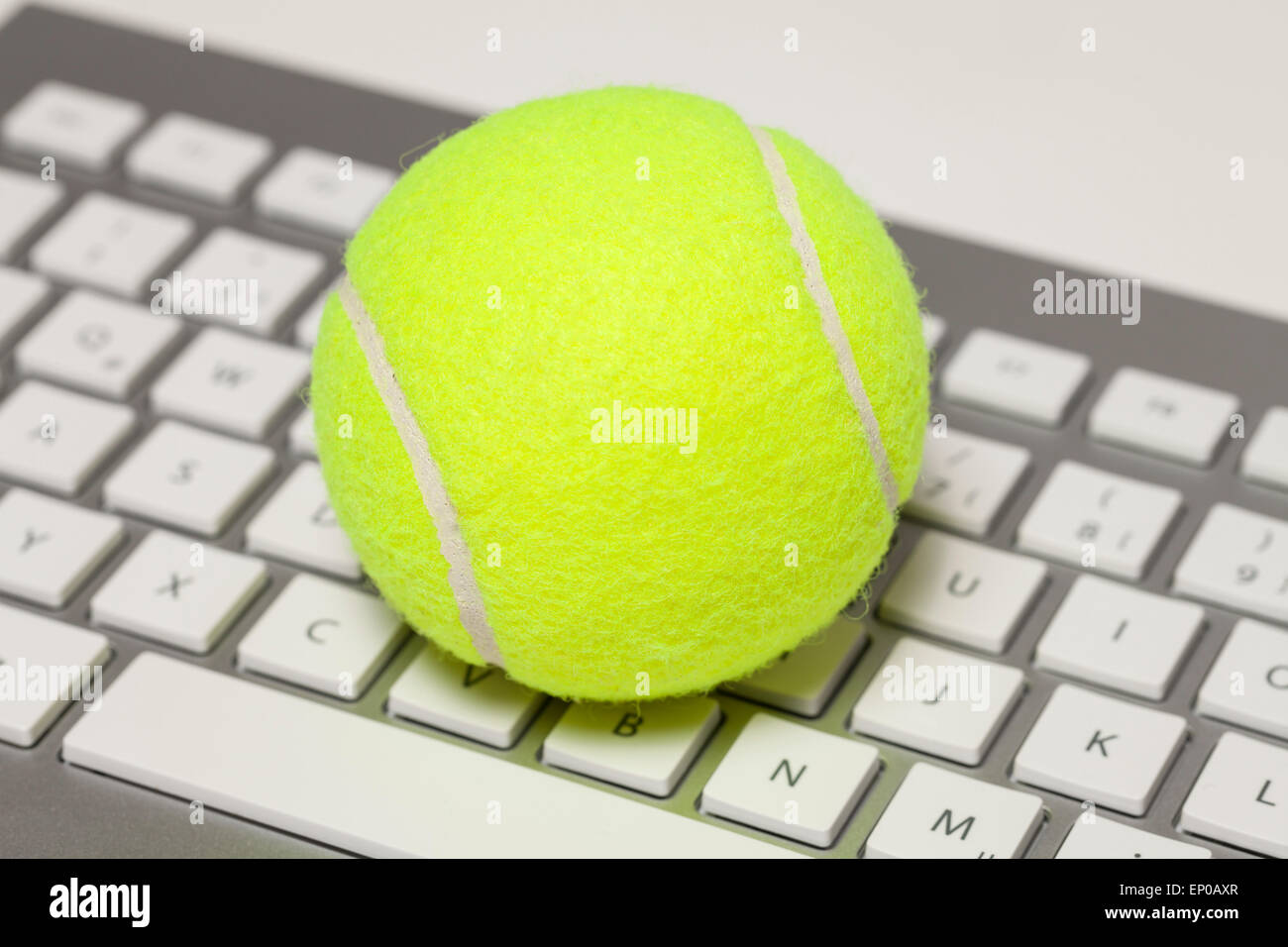 Tennis ball on keyboard Stock Photo - Alamy