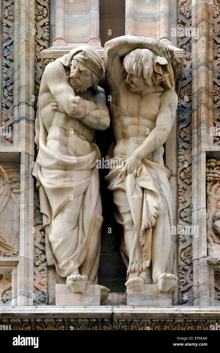 two statues in the front of the dome of milan Stock Photo - Alamy