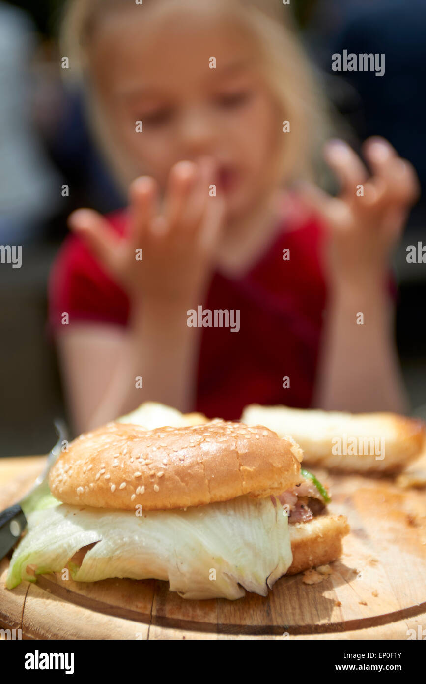 Girl Eating a Burger (hamburger) in restaurant Stock Photo - Alamy