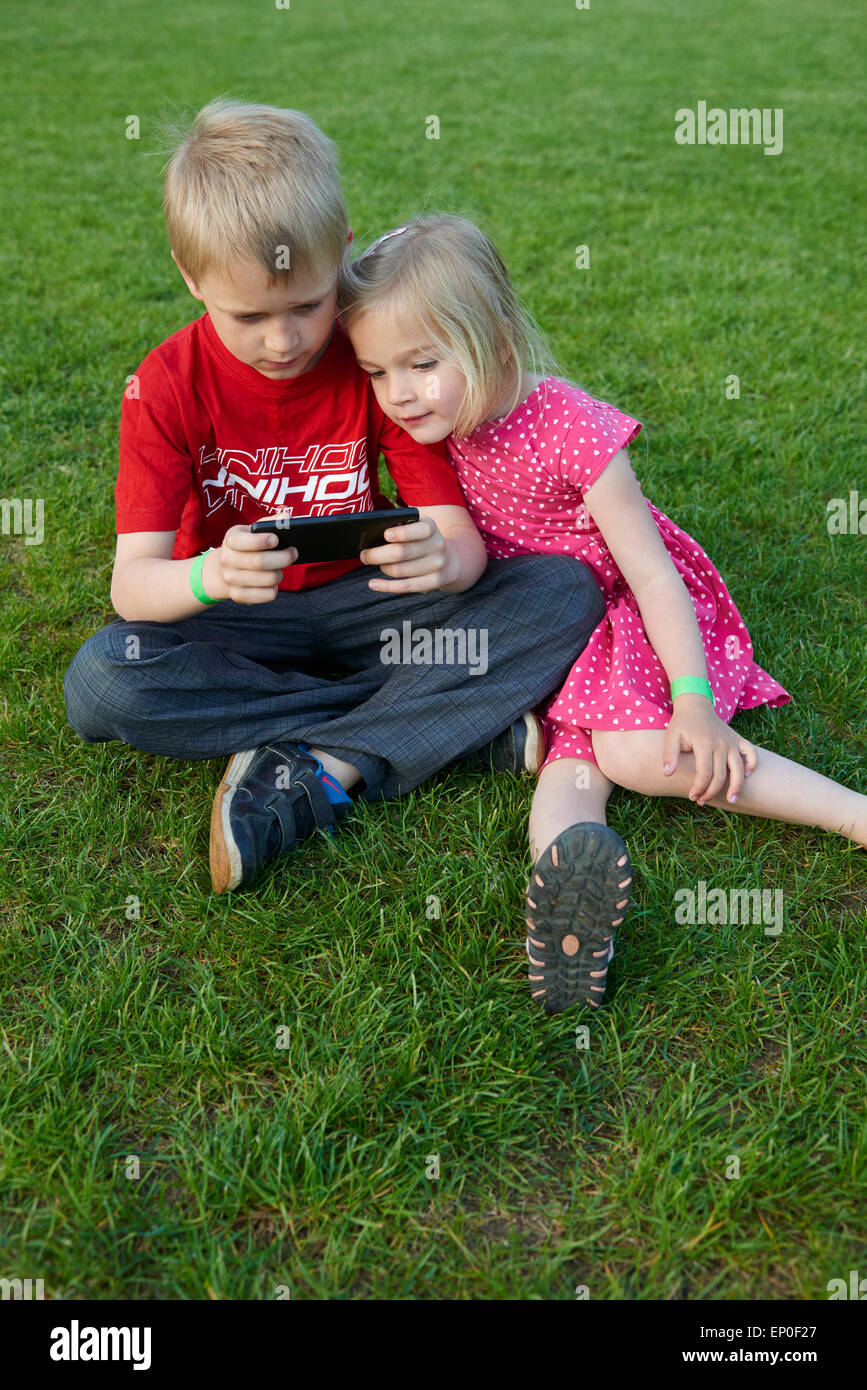 Boy playing with phone hi-res stock photography and images - Alamy