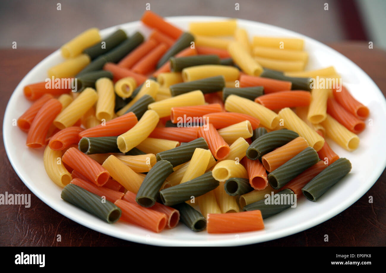 Italian tri coloured tortiglioni pasta on white plate Stock Photo - Alamy