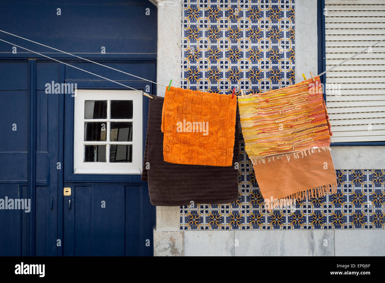 clothes drying on a washing line outside a traditional portuguese home ...