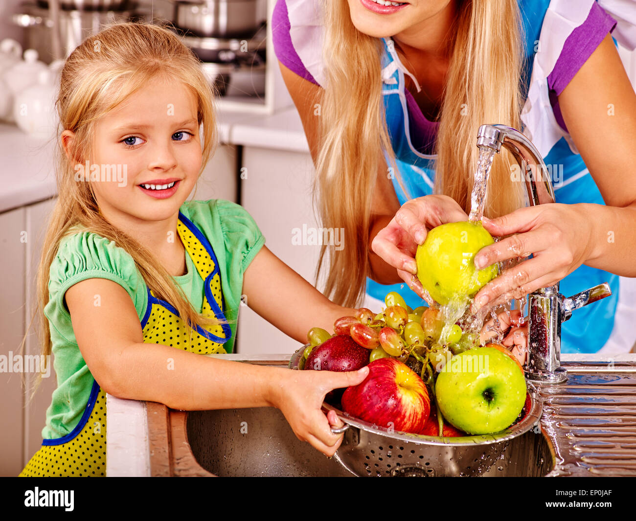 Children washing fruit at kitchen Stock Photo - Alamy