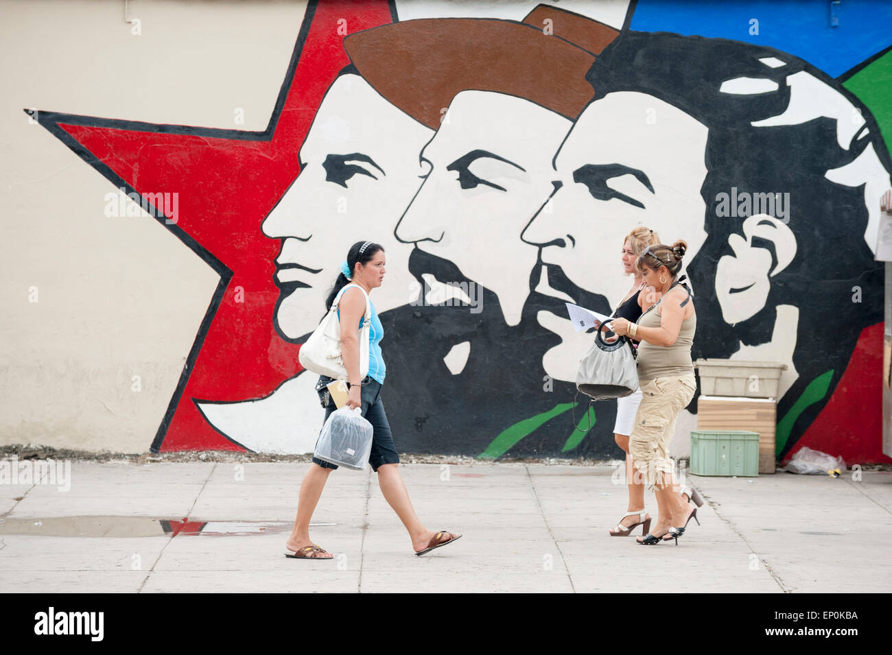 HAVANA, CUBA - JUNE 13, 2011: Cuban pedestirans walk in front of ...