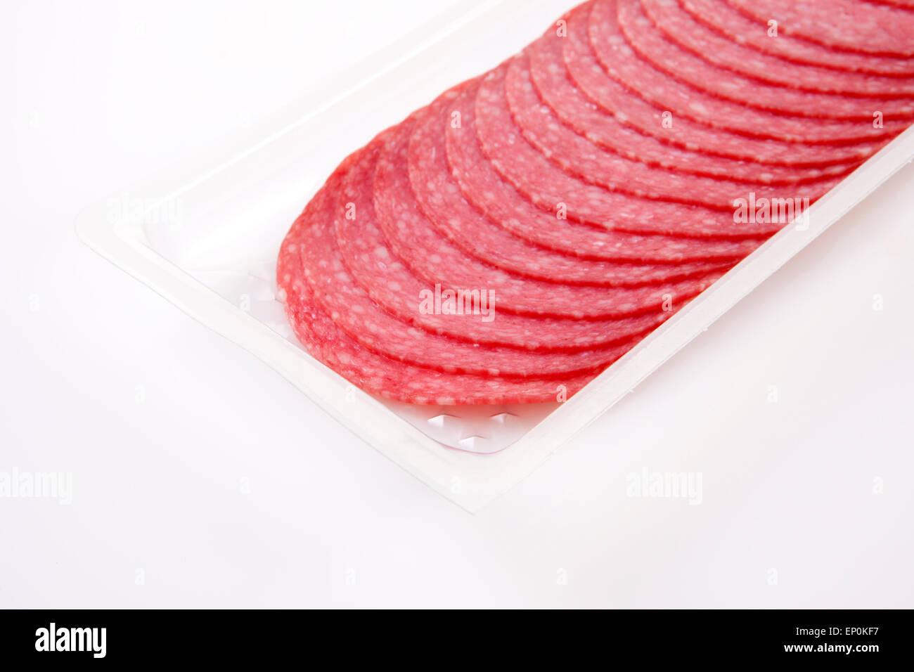 Sliced salami on the package. Isolated over white background Stock ...