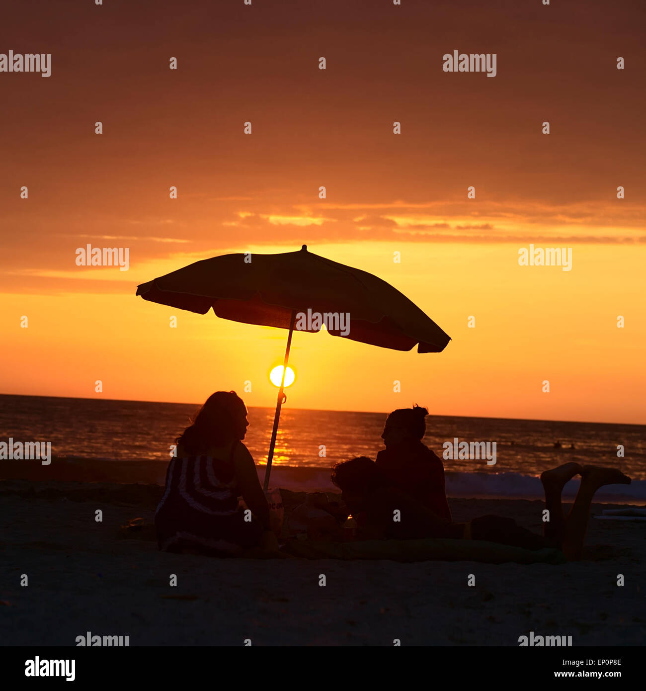 People sitting and lying below parasol on the sandy Cavancha beach at ...