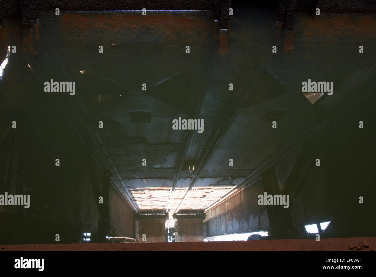 Reflection of rusting factory equipment in pool of waste water Stock ...