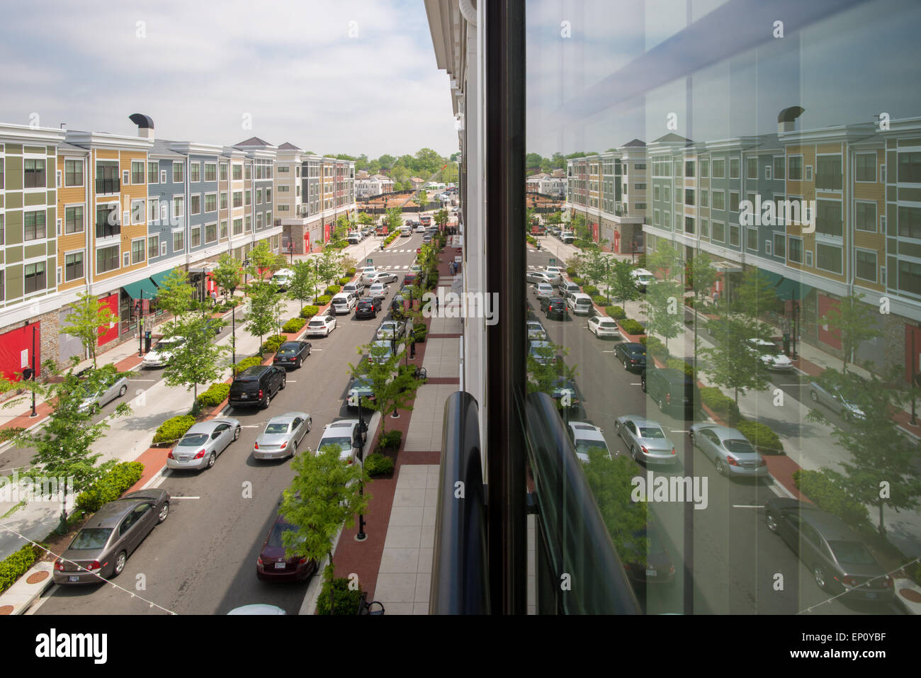 Window reflections showing shopping, town homes, and cars at Rhode ...