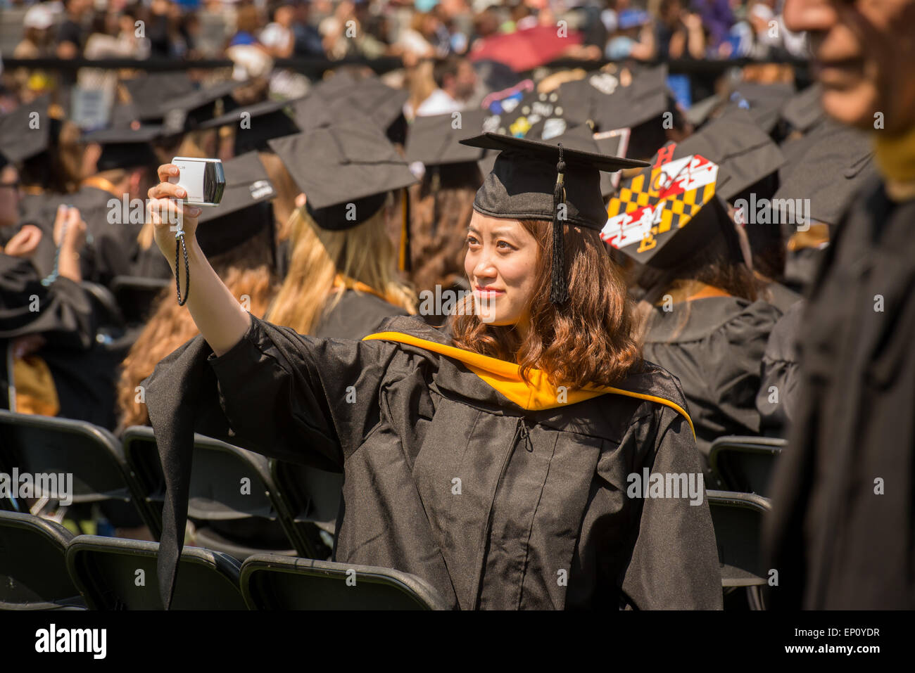 College graduate taking a photo of herself in Baltimore, Maryland, USA ...