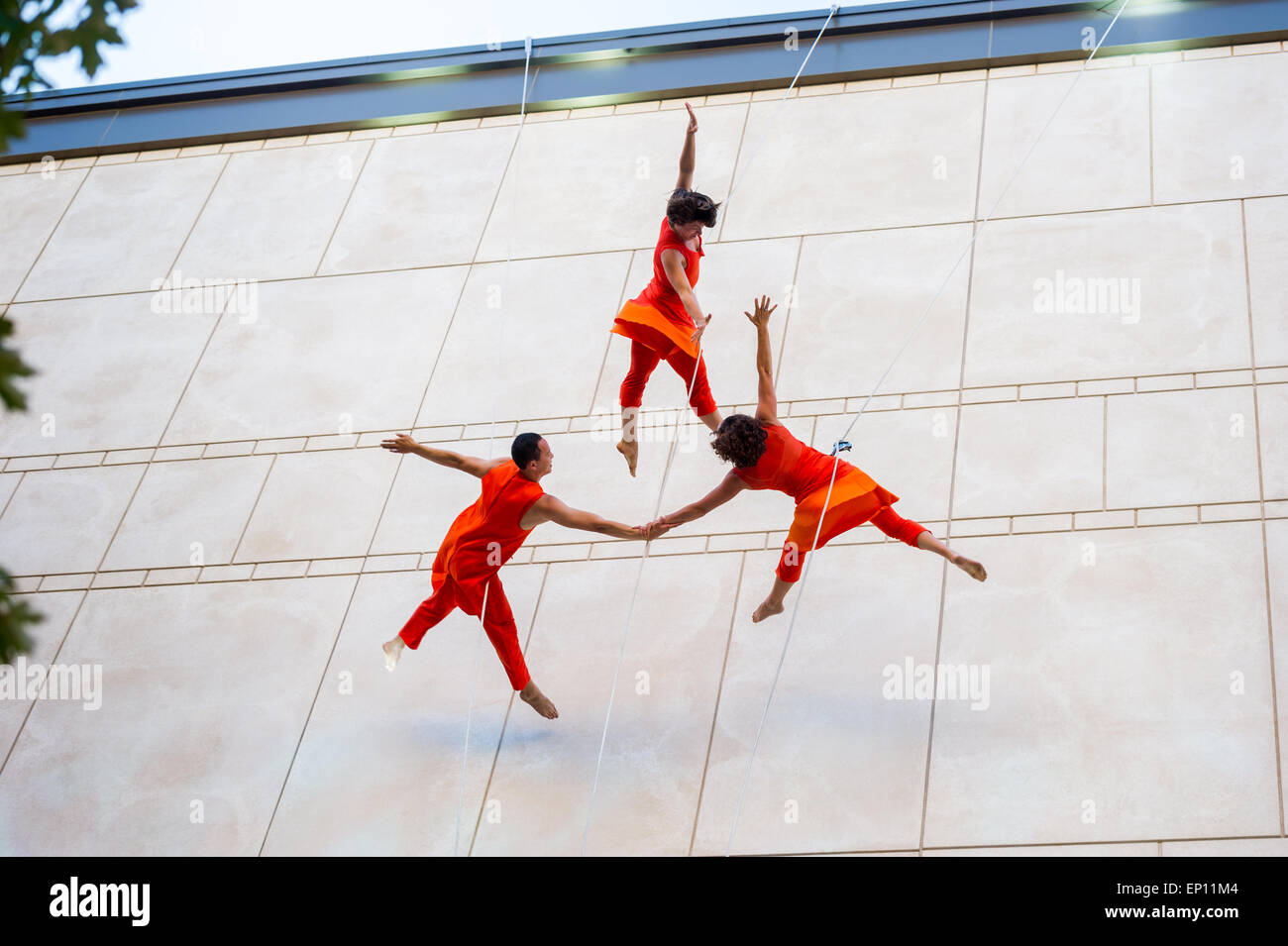 Performers dancing on side of building Stock Photo - Alamy