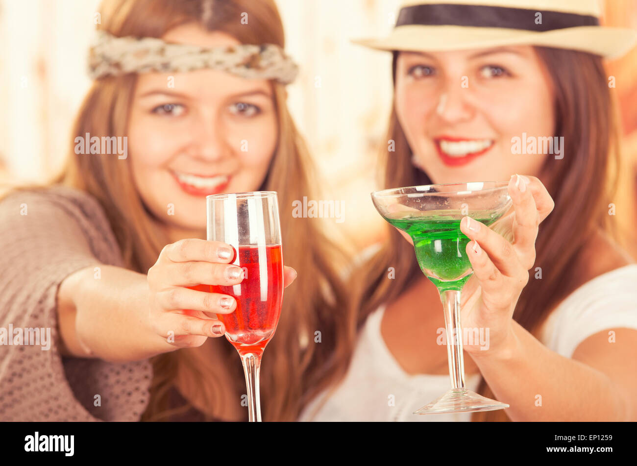 Two fun beautiful girls holding their cocktails Stock Photo - Alamy