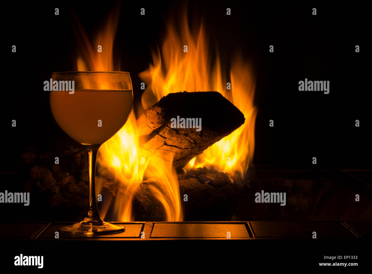 Wine glass by fire for winery adventure background image Stock Photo ...