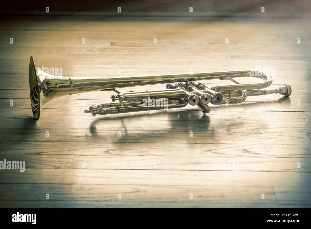 Old rusty trumpet lays on wooden floor in the morning light Stock Photo ...