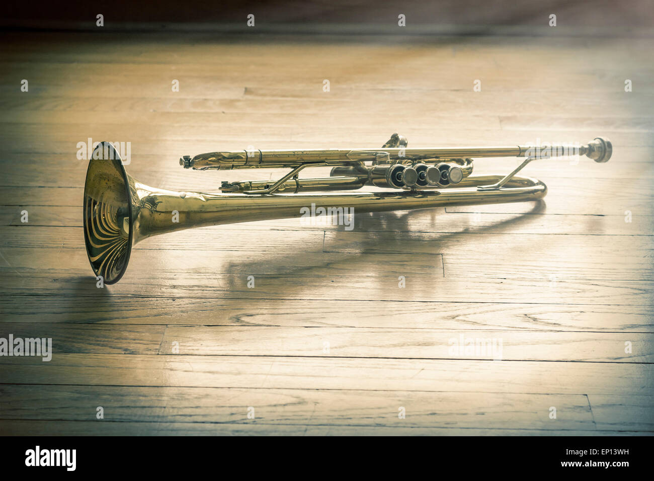 Old rusty trumpet lays on wooden floor in the morning light Stock Photo ...