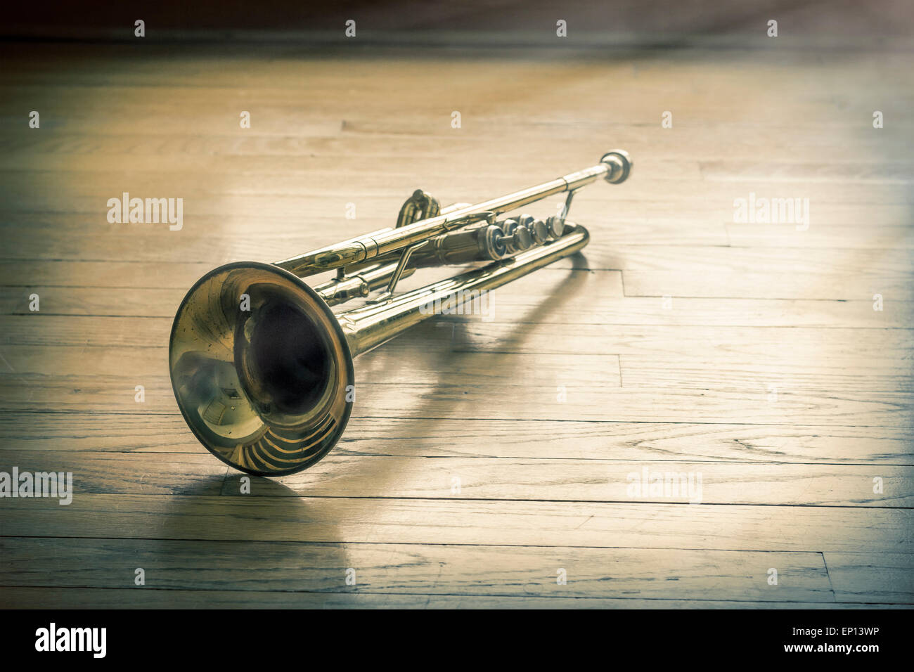 Old rusty trumpet lays on wooden floor in the morning light Stock Photo ...