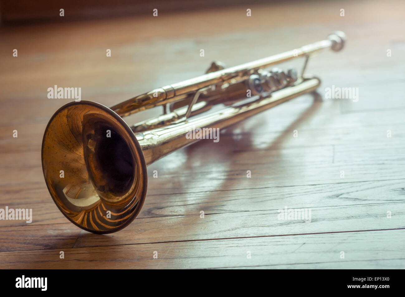 Old rusty trumpet lays on wooden floor in the morning light Stock Photo ...