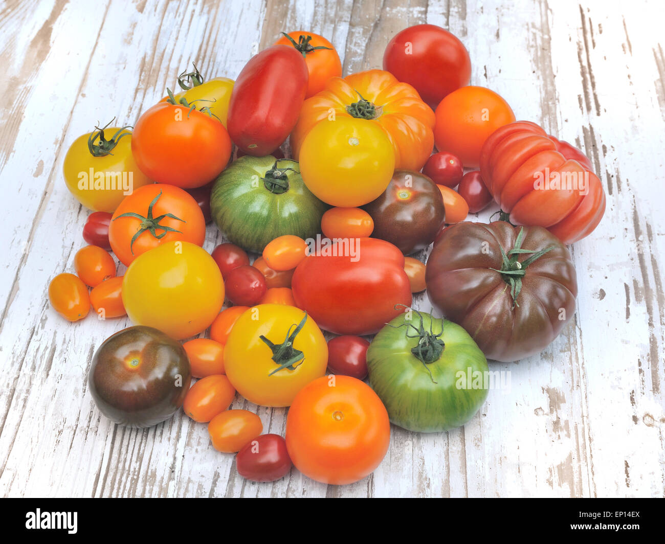 differents color varieties of tomatoes on a wooden white table Stock ...