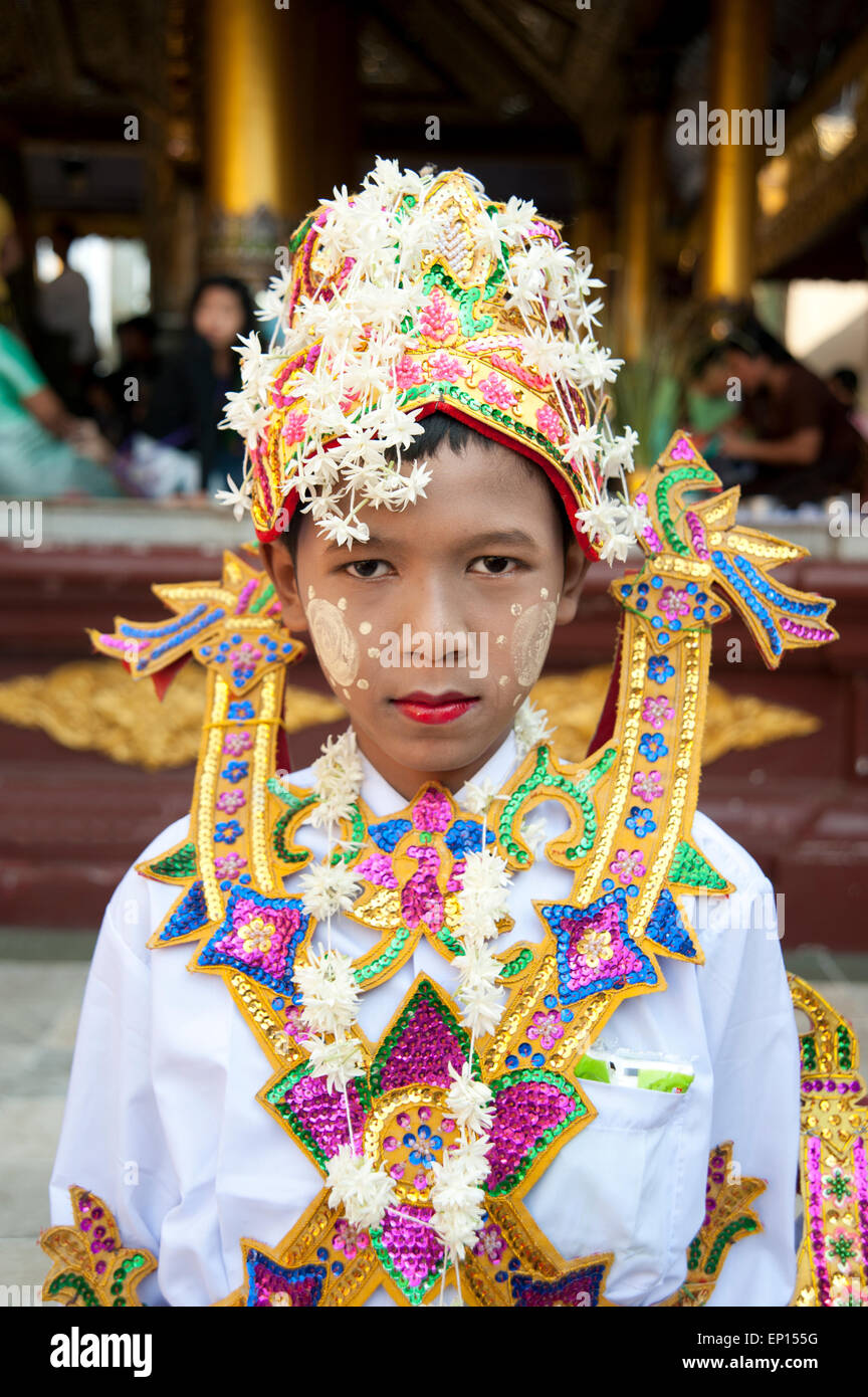 Portrait of a Burmese boy dressed in traditional costume wearing face ...