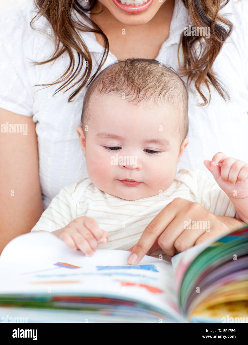 Bright mother showing images in a book to her cute little son Stock ...
