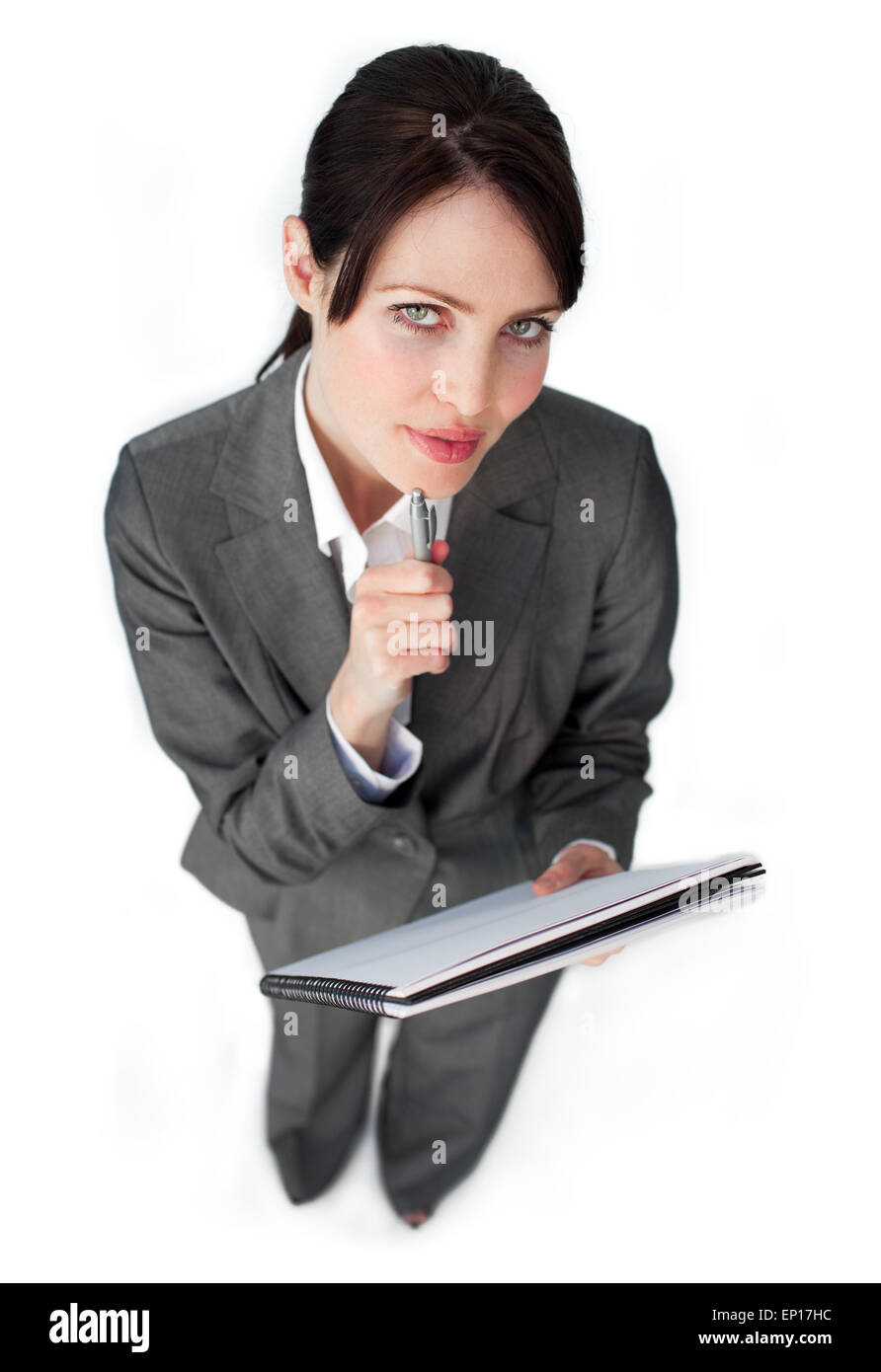 Serious businesswoman taking notes against a white bakground Stock ...