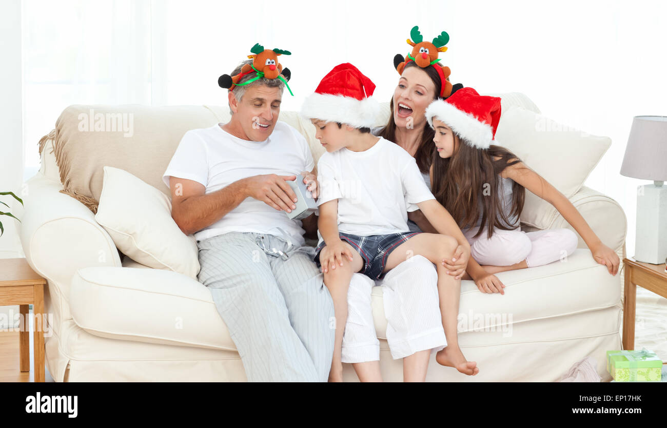 Family during Christmas day looking at their presents Stock Photo - Alamy
