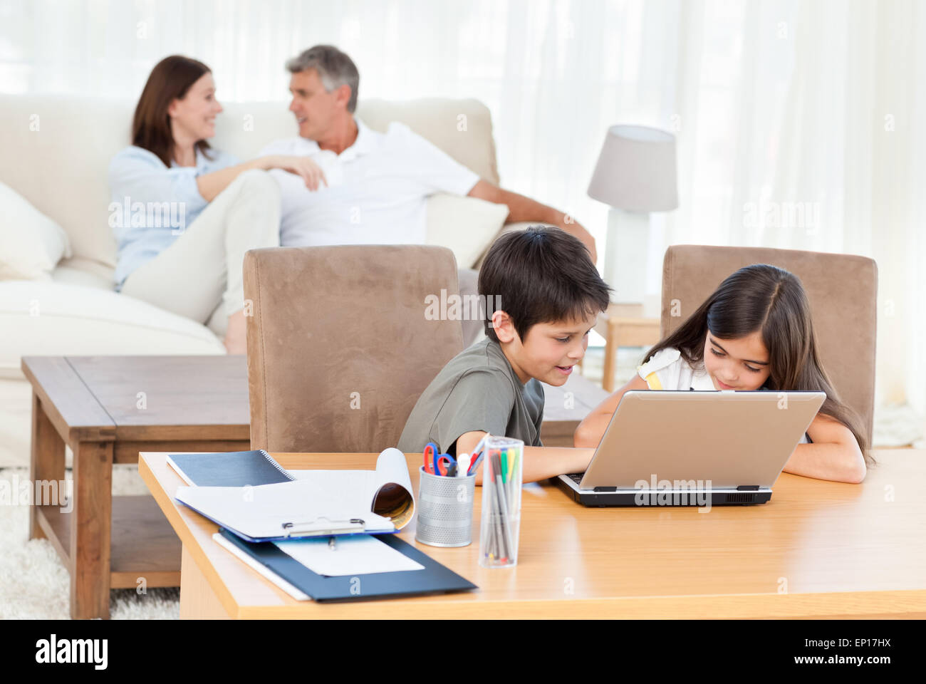 Children working on their laptop at home Stock Photo - Alamy