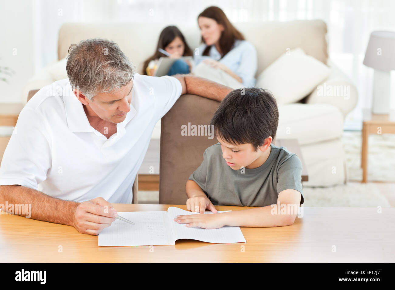 Father helping her son with his homework Stock Photo - Alamy