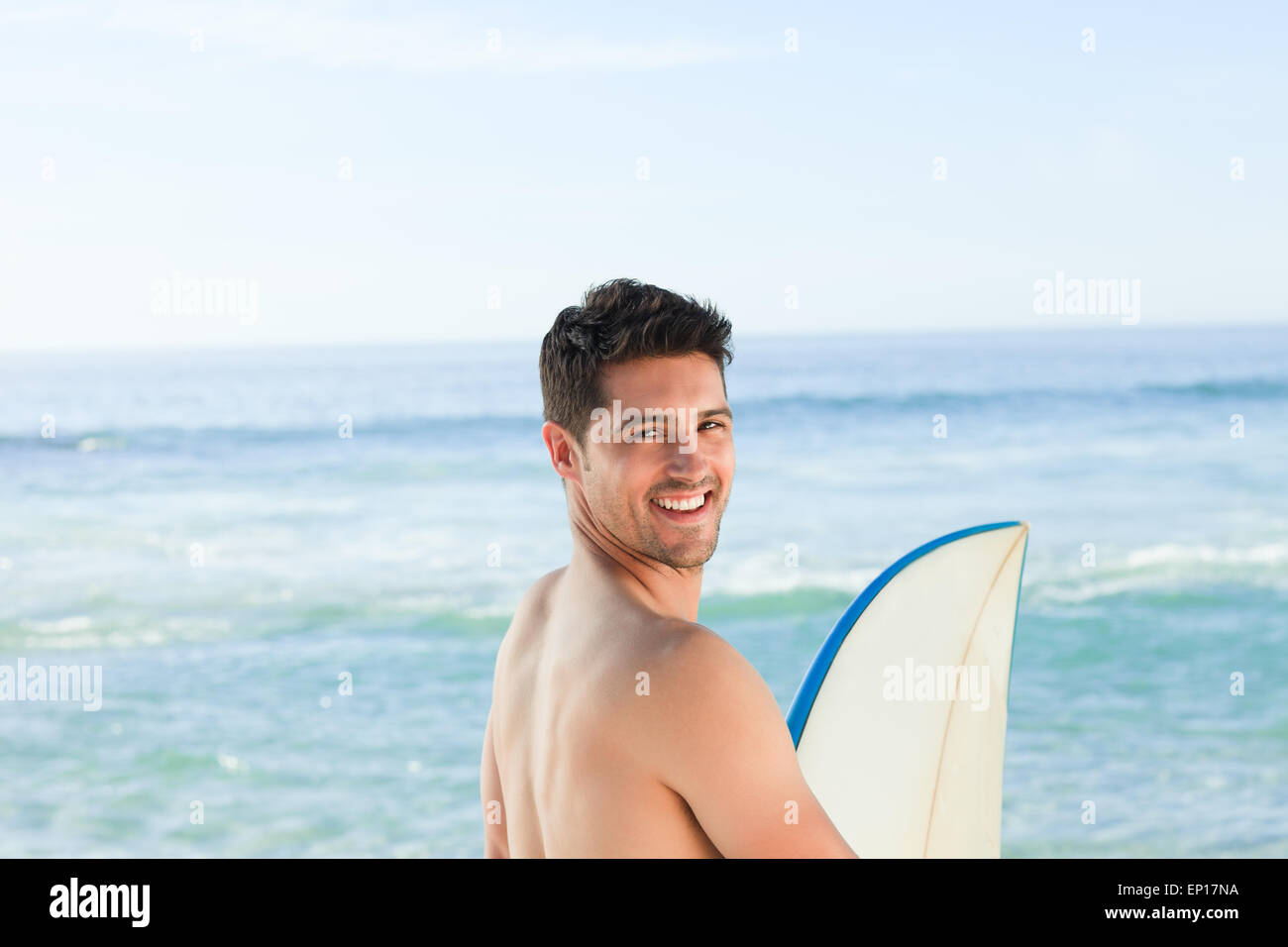 Handsome man beside the sea with his surfboard Stock Photo - Alamy