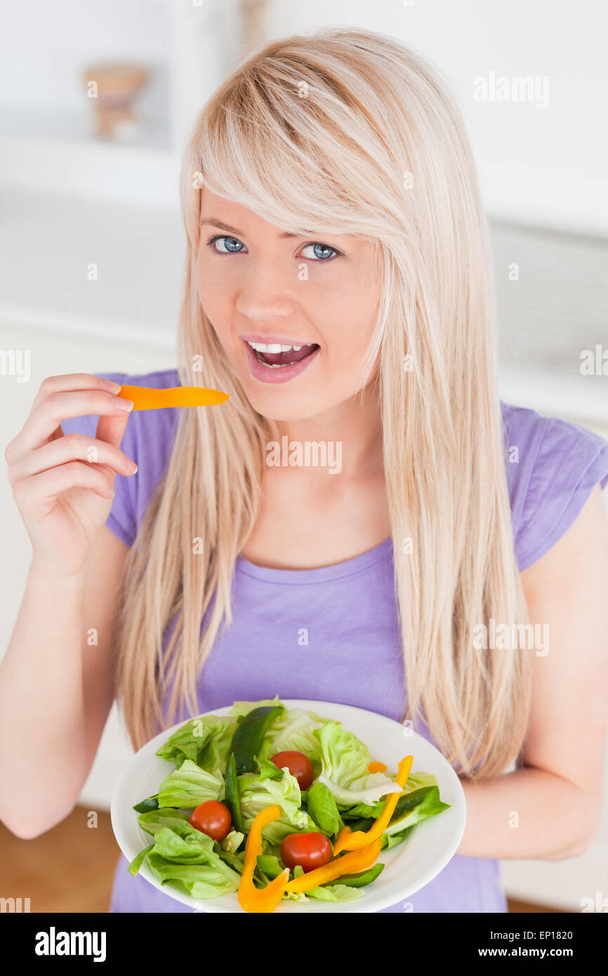 Beautiful smiling female eating her salad Stock Photo - Alamy