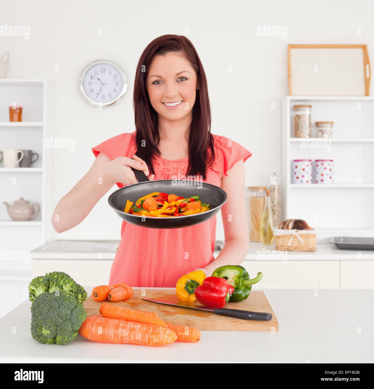 Gorgeous red-haired woman cooking vegetables in the kitchen Stock Photo ...