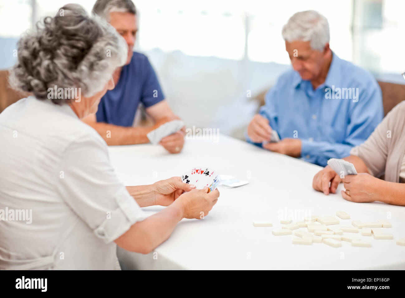 Retired people playing cards together Stock Photo - Alamy