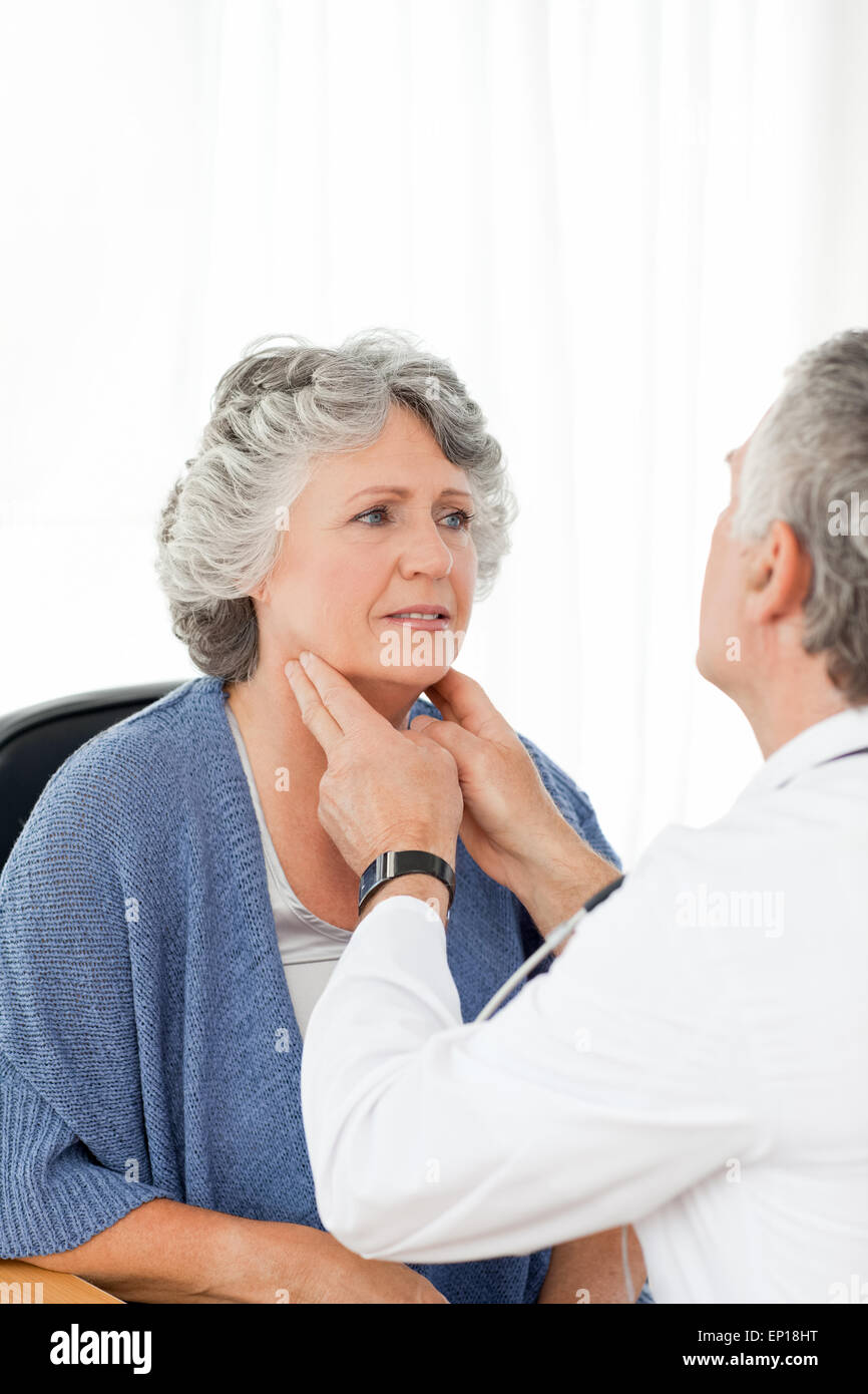 A senior doctor doing an examination of his patient Stock Photo - Alamy