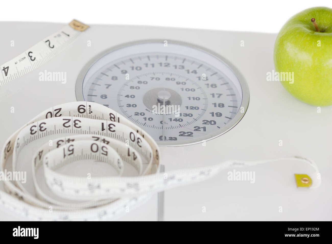 Green apple with a tape measure and a weigh-scale Stock Photo - Alamy