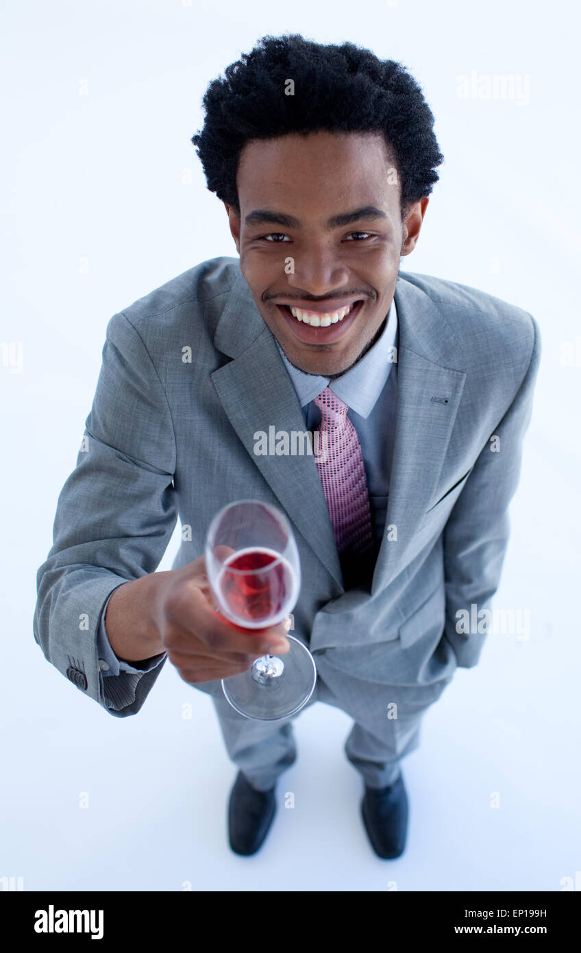 Smiling Afro-American businessman holding a glass of wine Stock Photo ... Smiling Afro-American businessman holding a glass of wine Stock Photo ...