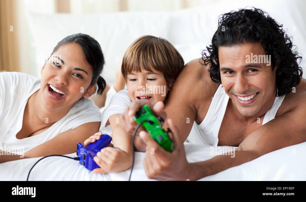 Happy parents and son playing video games Stock Photo - Alamy