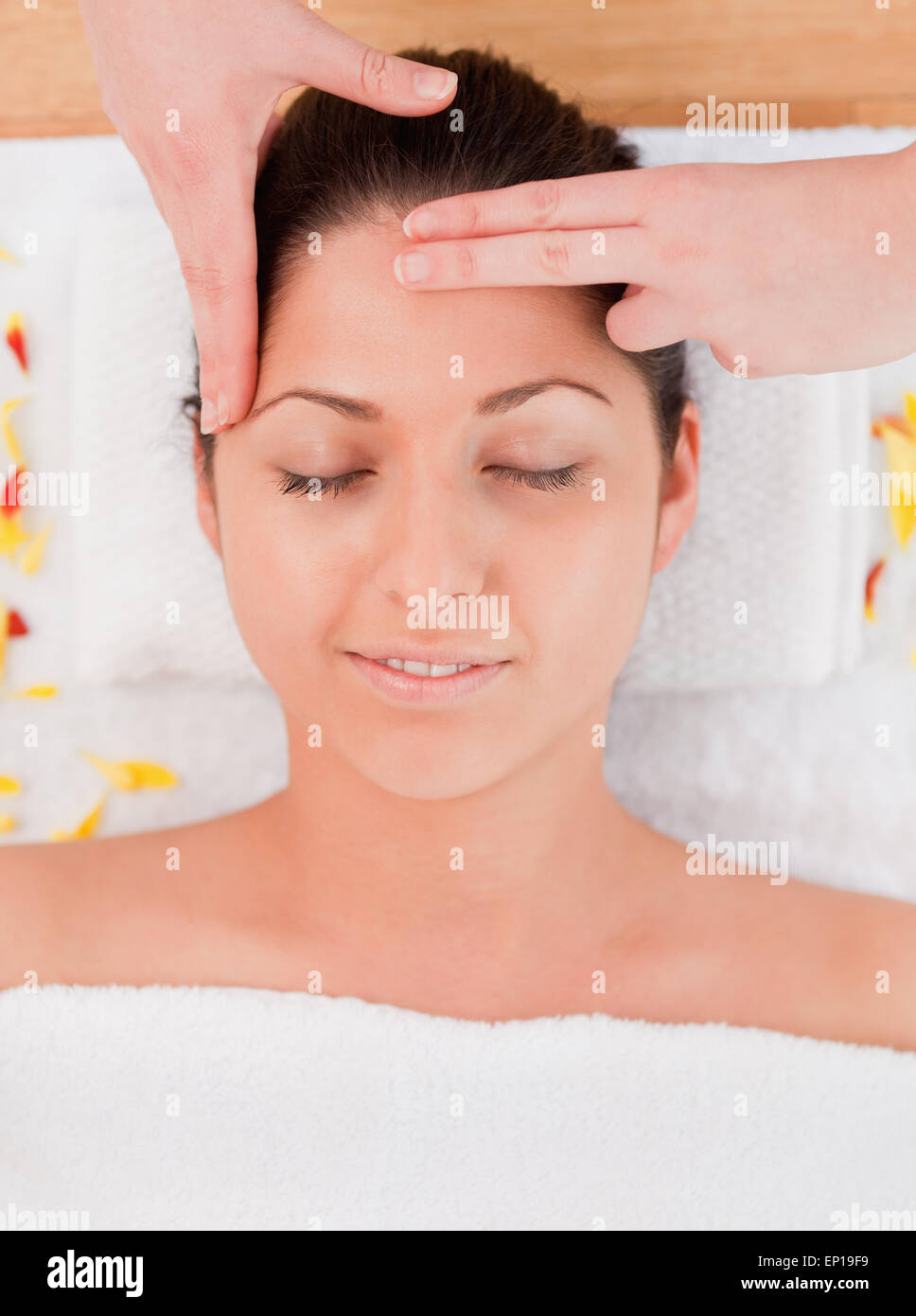 brunette having a forehead massage Stock Photo - Alamy