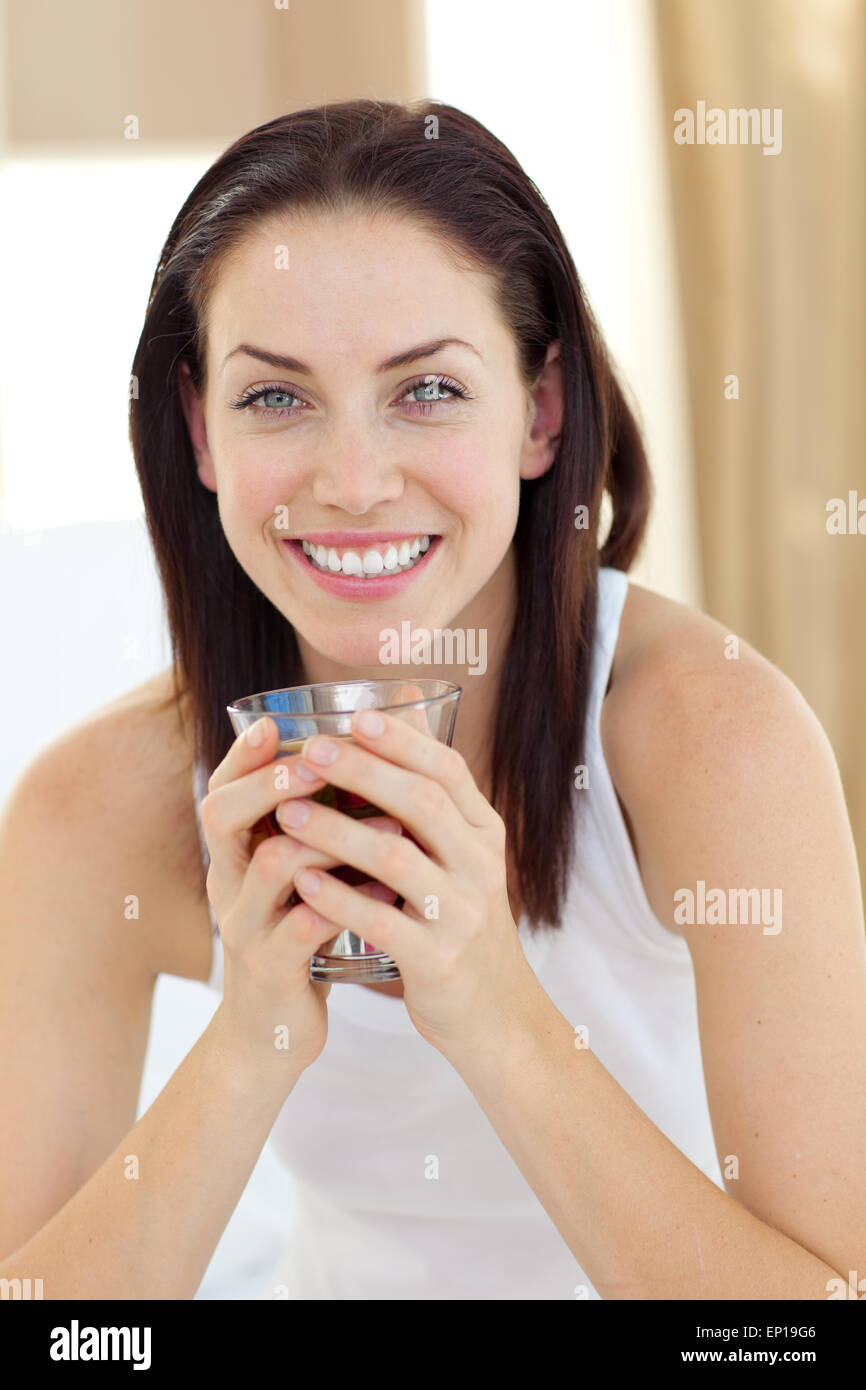 Smiling woman drinking tea Stock Photo - Alamy