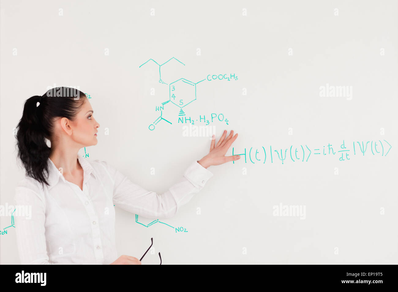 Scientist explaining a formula written on a white board Stock Photo - Alamy