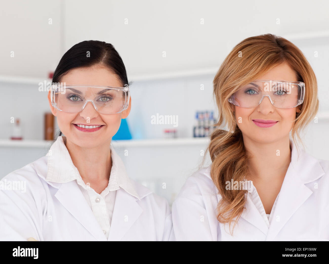 Two female scientists with safety glasses looking at the camera Stock ...