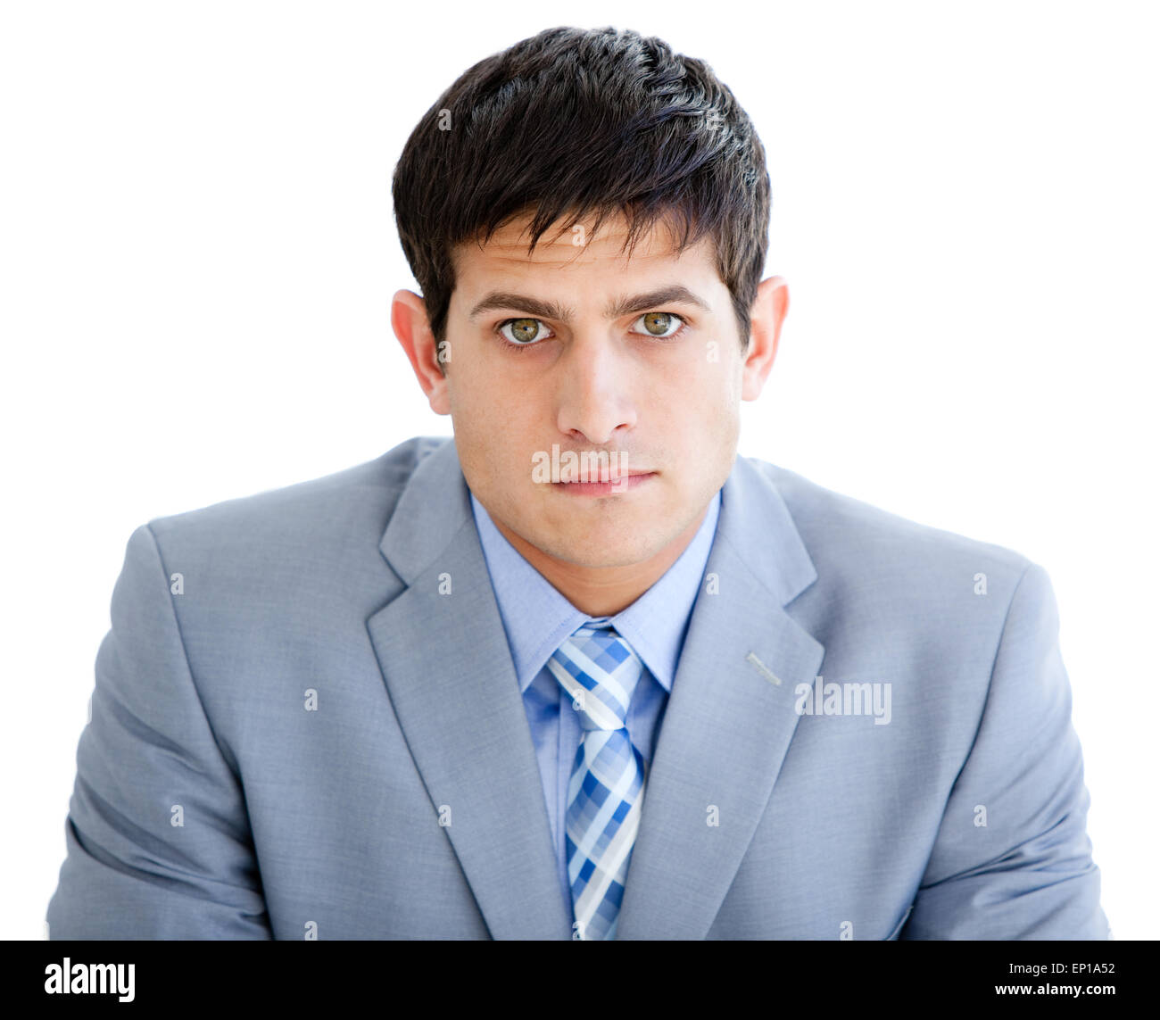 Portrait of a serious young businessman against a white background ...
