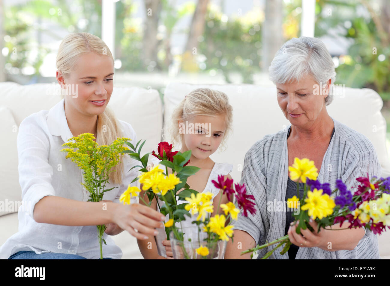 Radiant family with flowers Stock Photo - Alamy