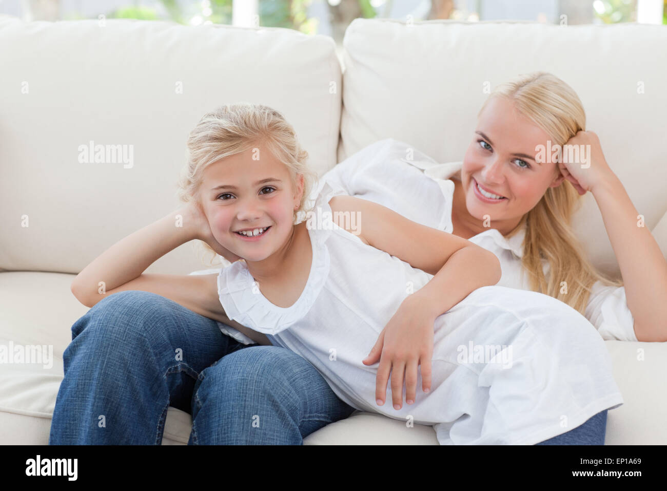 Beautiful woman lying down with her daughter Stock Photo - Alamy