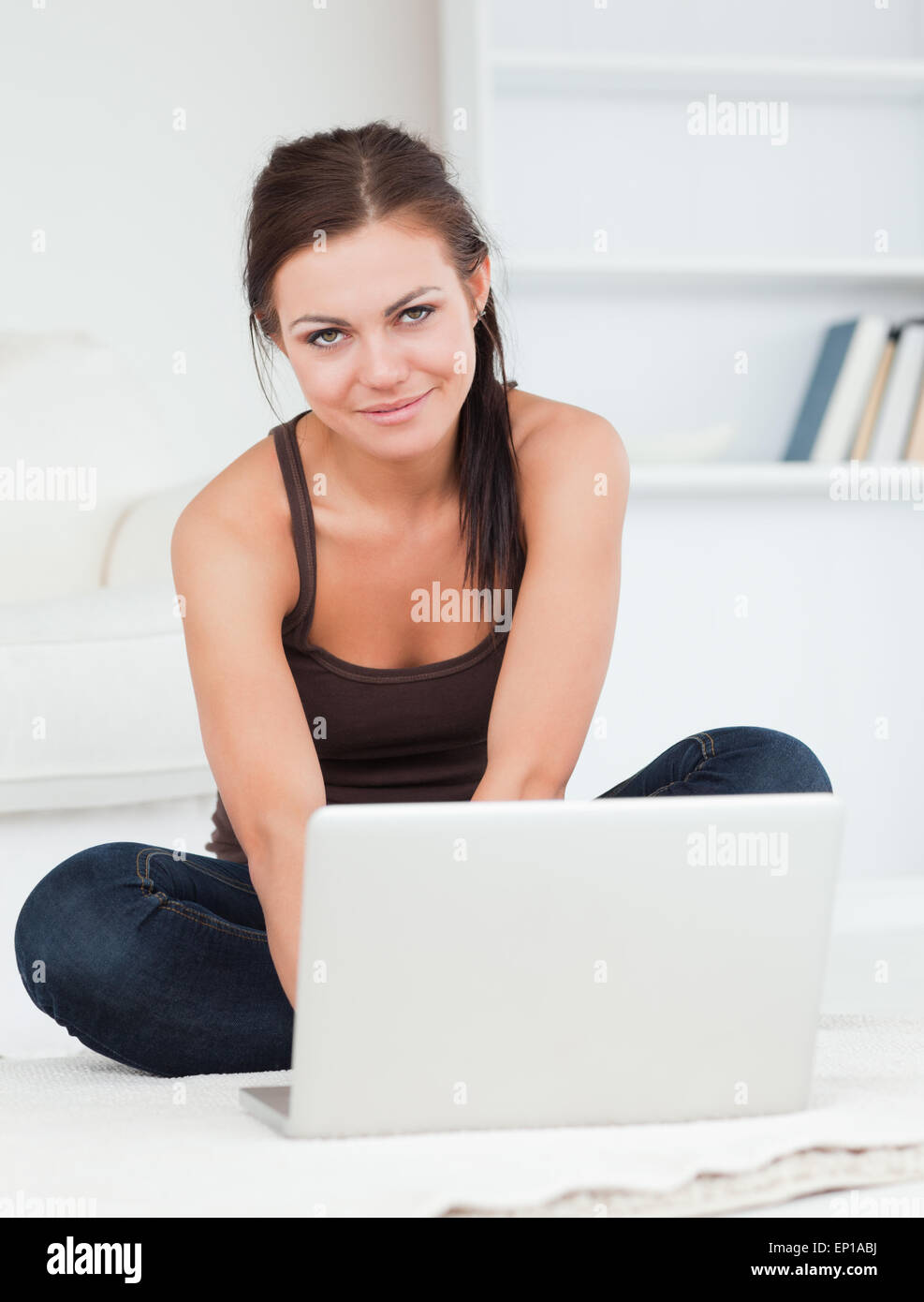 Beautiful dark-haired woman using her laptop Stock Photo - Alamy