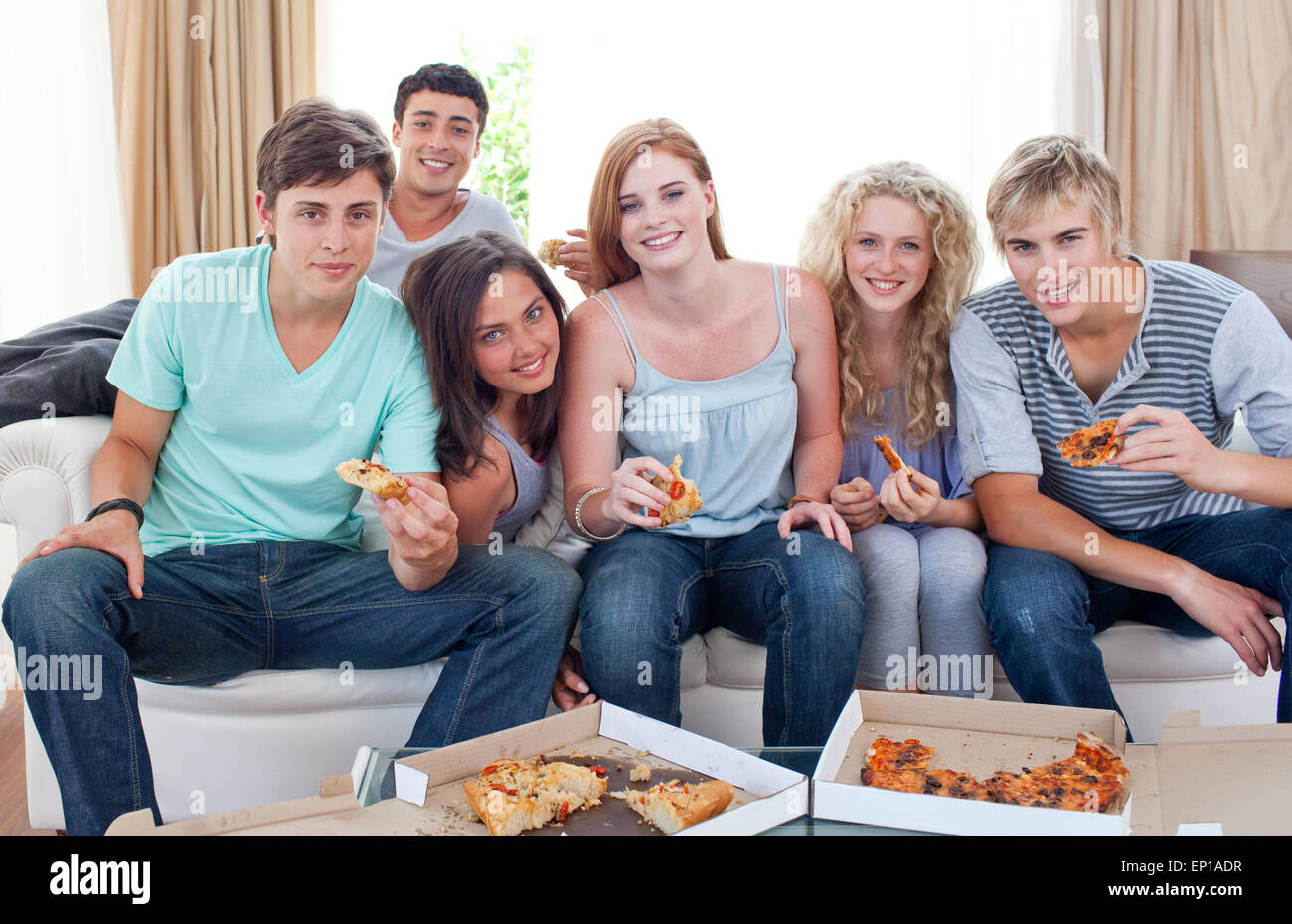 Adolescents eating pizza at home Stock Photo - Alamy