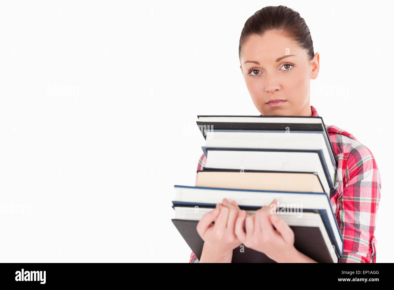 Sad female posing with books while standing Stock Photo - Alamy