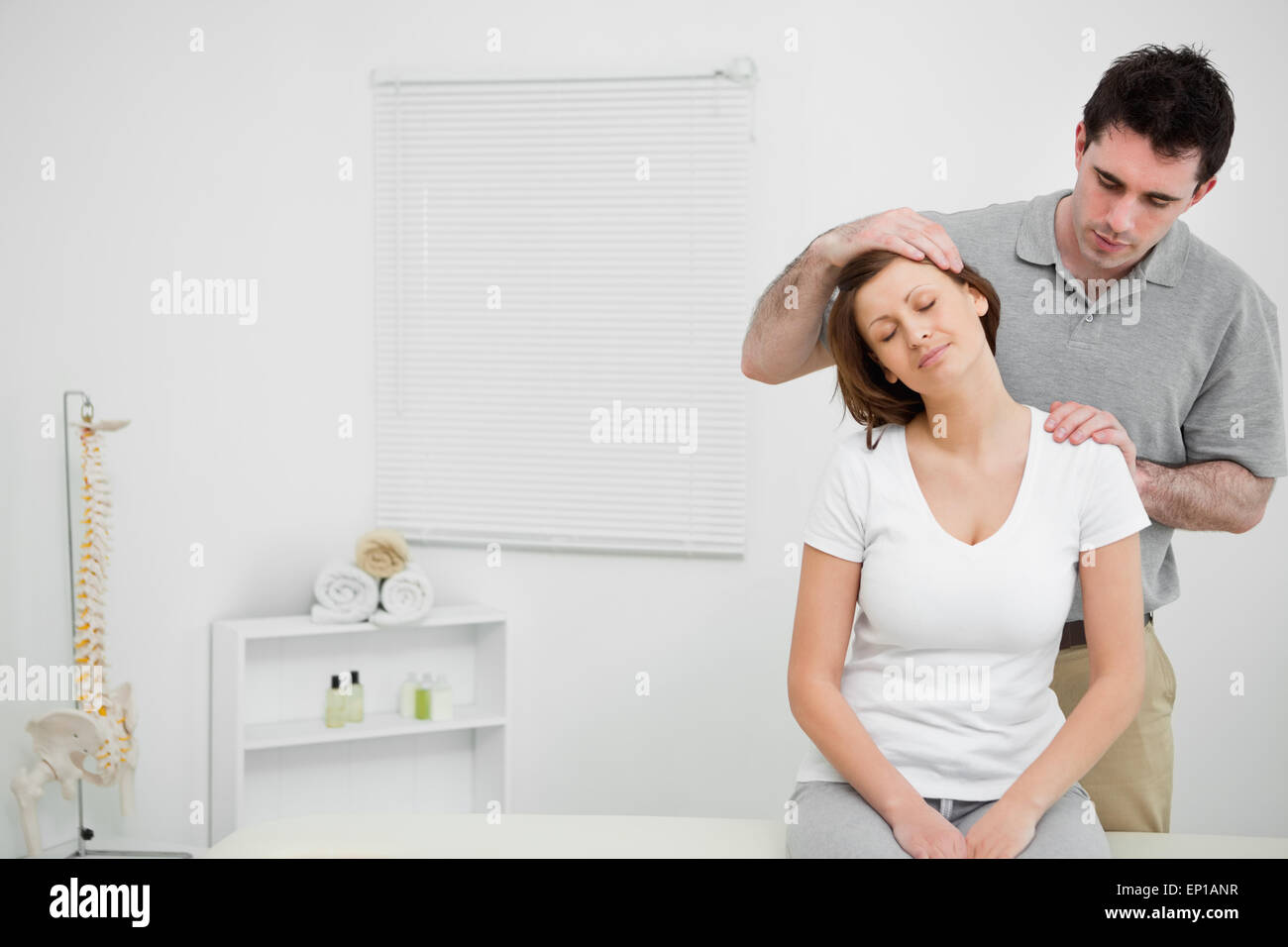 Doctor examining the neck of his patient while stretching it Stock ...