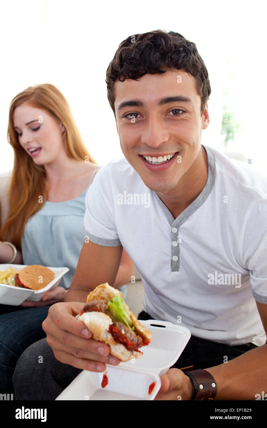 Friends eating burgers and fries Stock Photo - Alamy