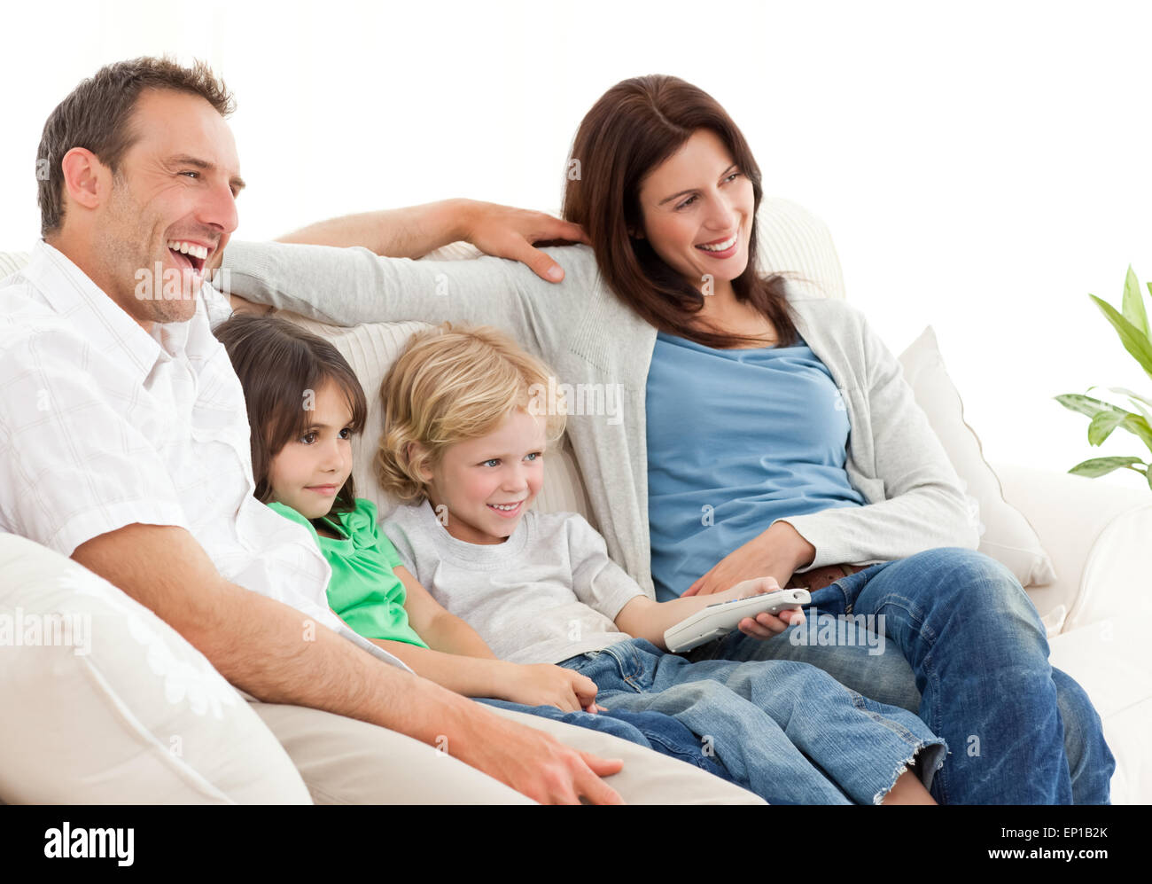 Happy family watching television together Stock Photo - Alamy
