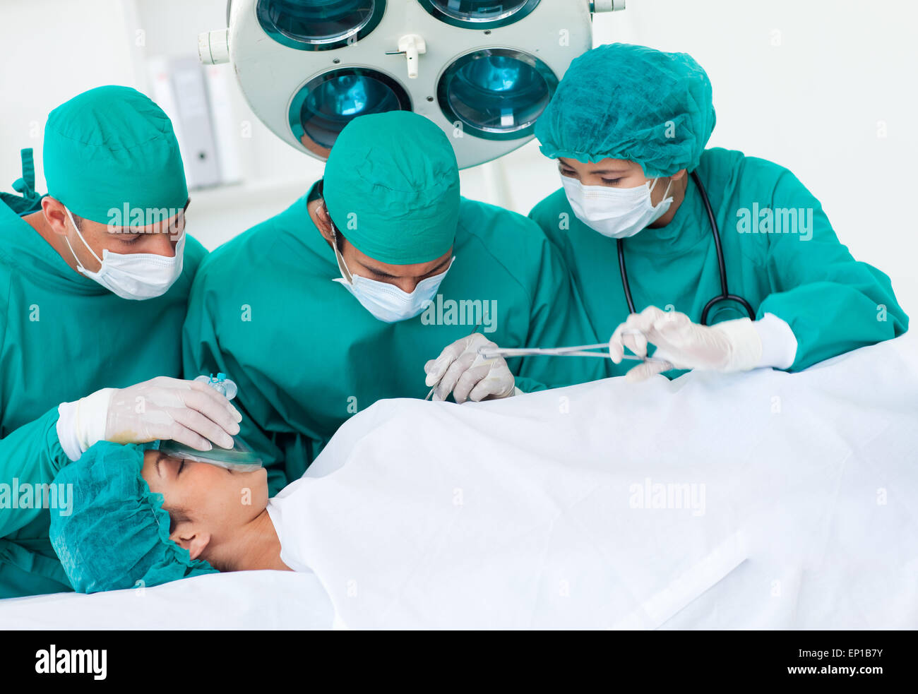 Surgeons near patient lying on an operating table Stock Photo - Alamy