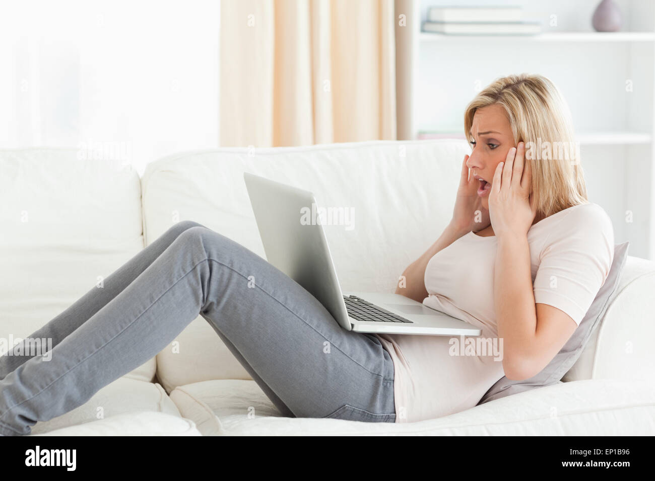 Blonde woman having trouble her laptop Stock Photo - Alamy